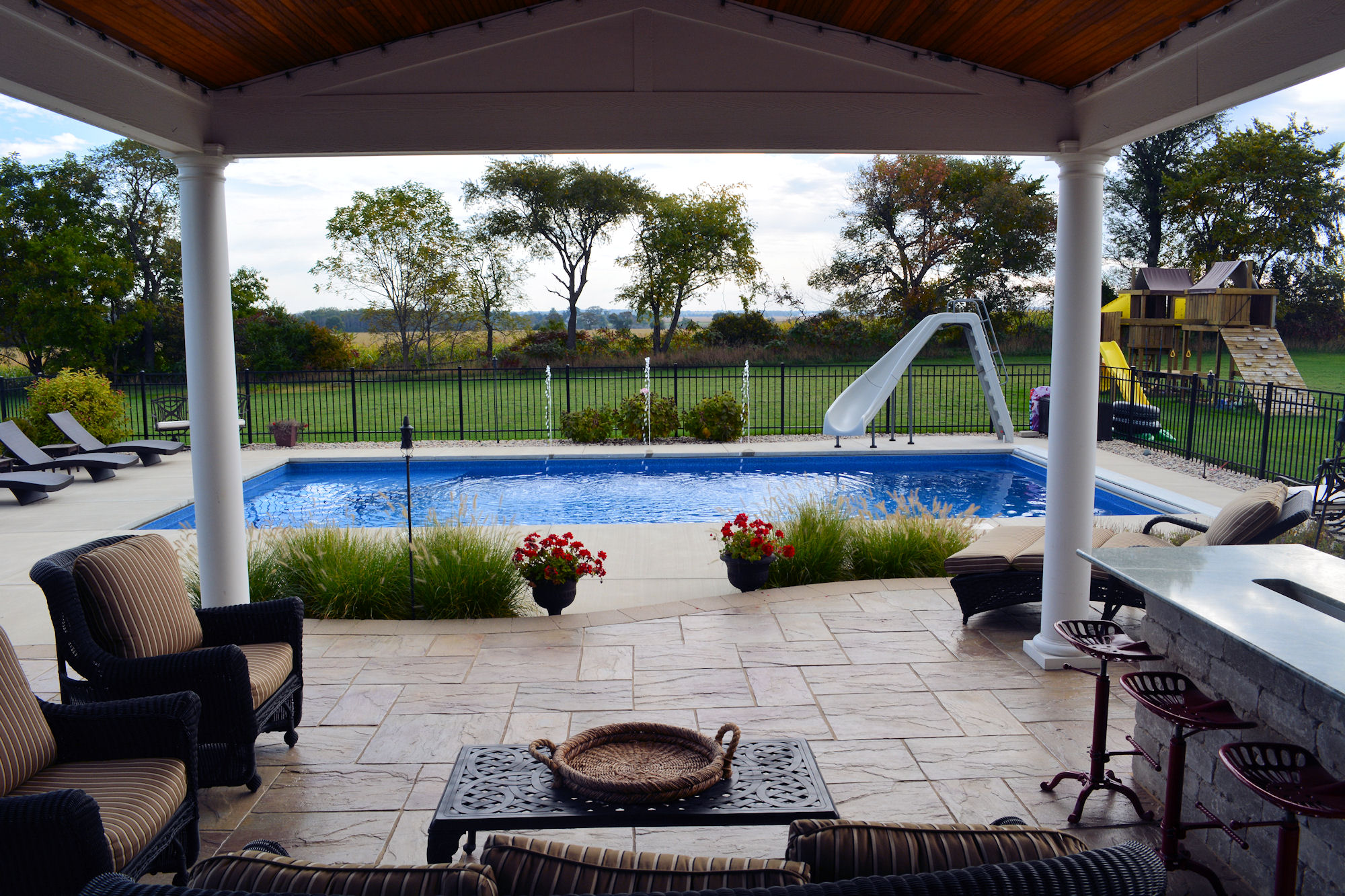 A covered conversation area poolside provides a retreat from the sun ...