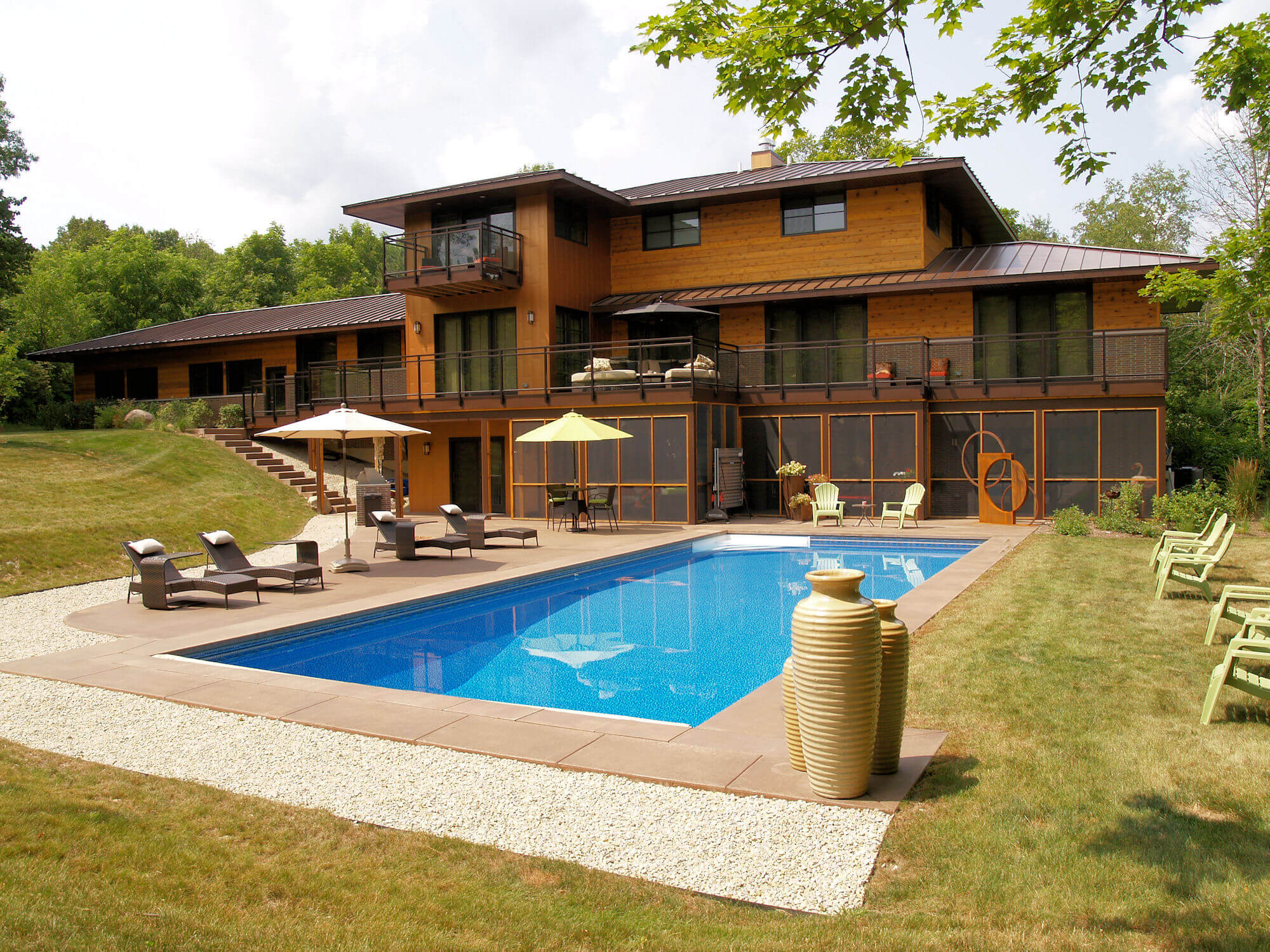 A pool designed to complement this home's prairie-style architecture ...