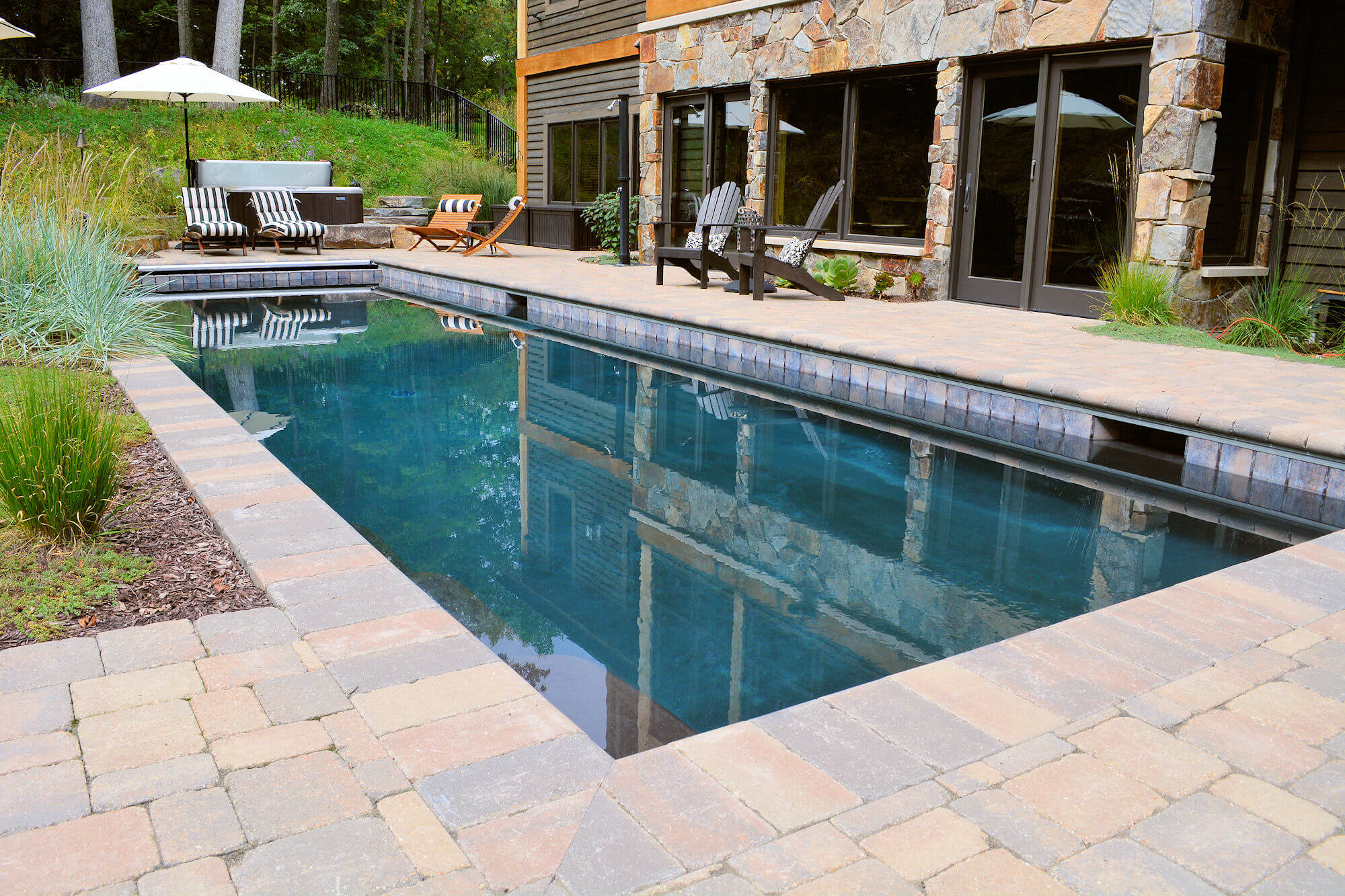 Custom stone tile and native landscaping give this pool a one-of-a-kind ...