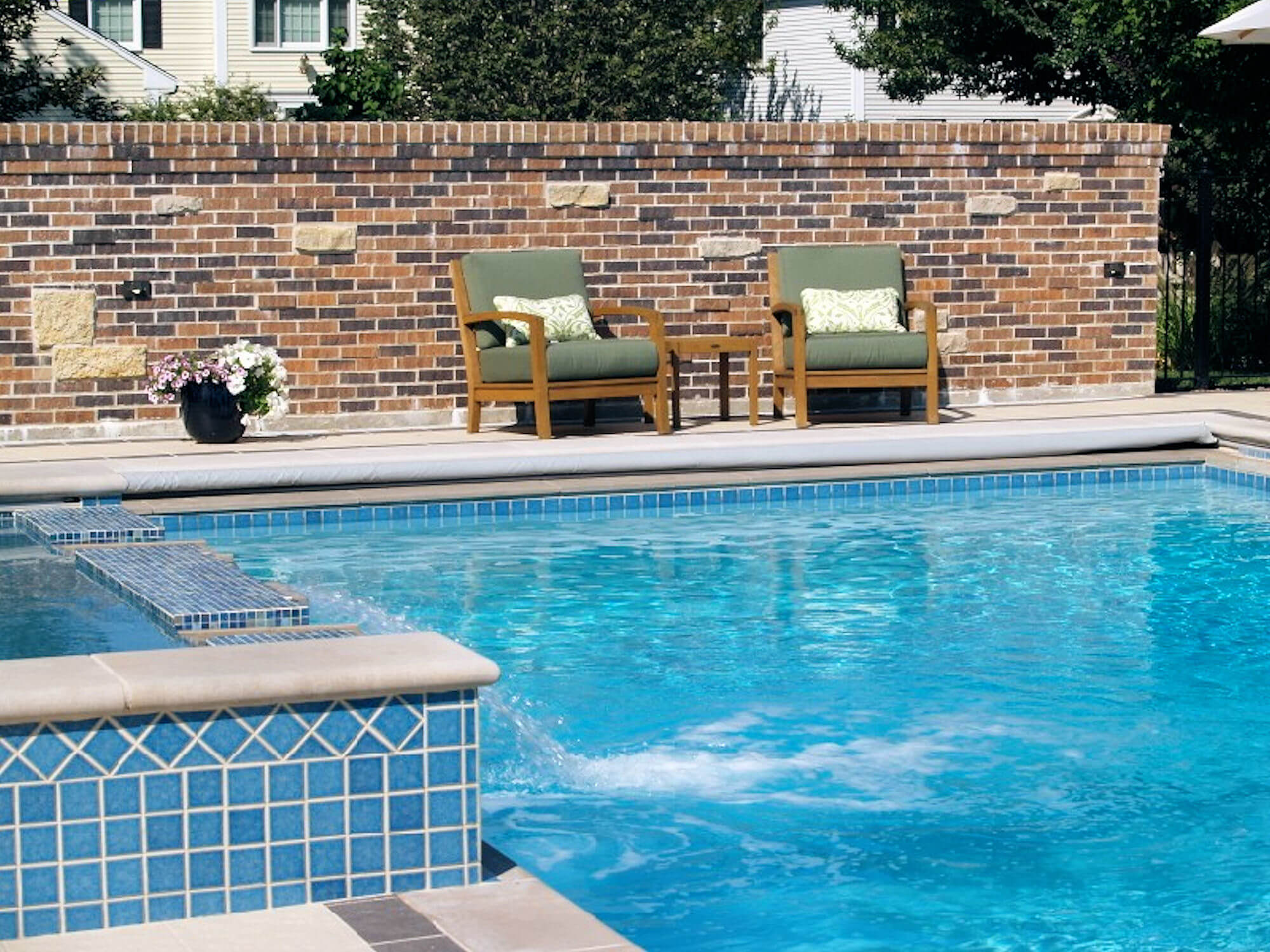 A custom spa overflows into the pool below. (65) - Arvidson Pools and Spas