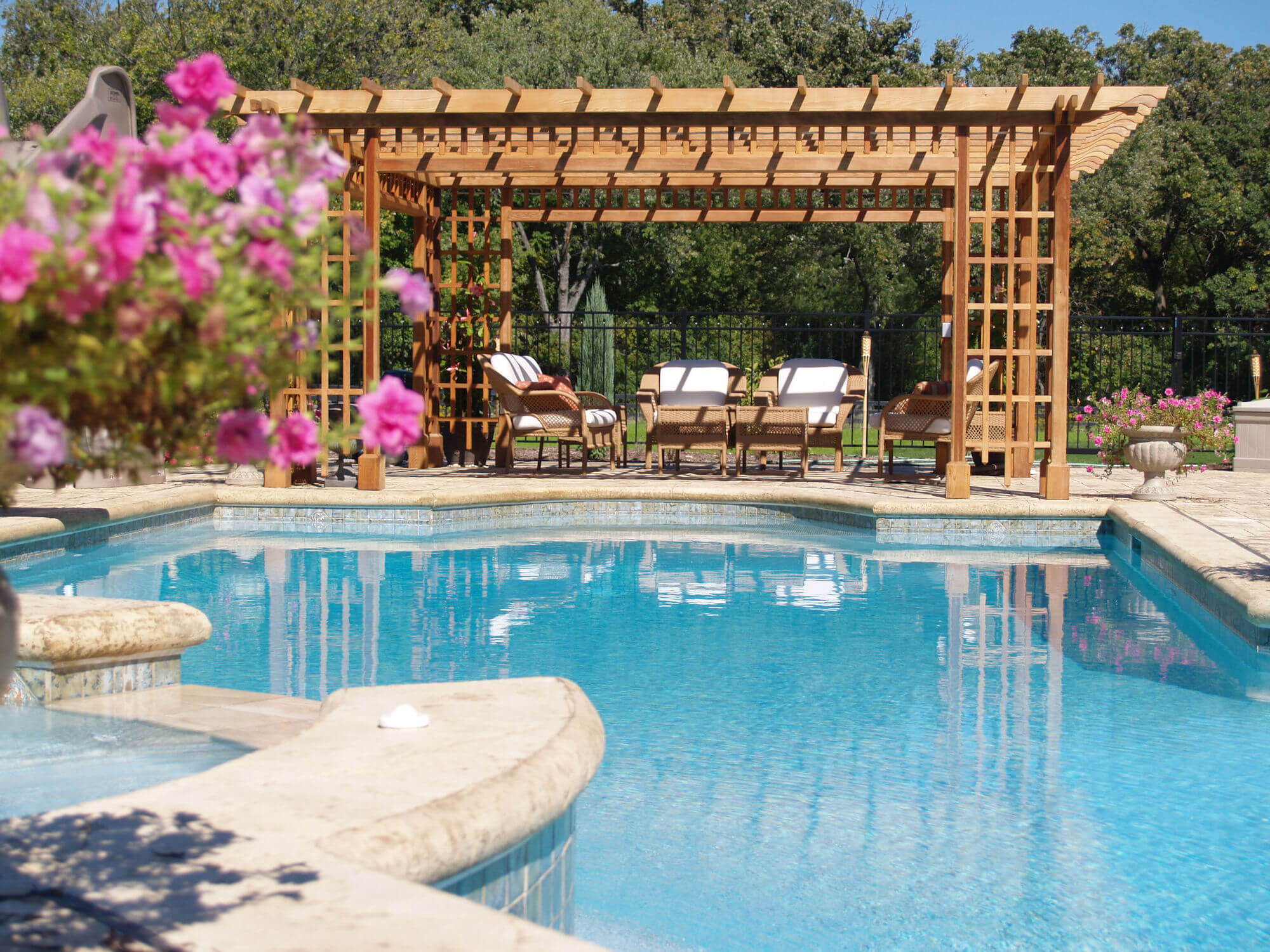 Landscaping, a pergola, and custom tile create a beautiful pool ...